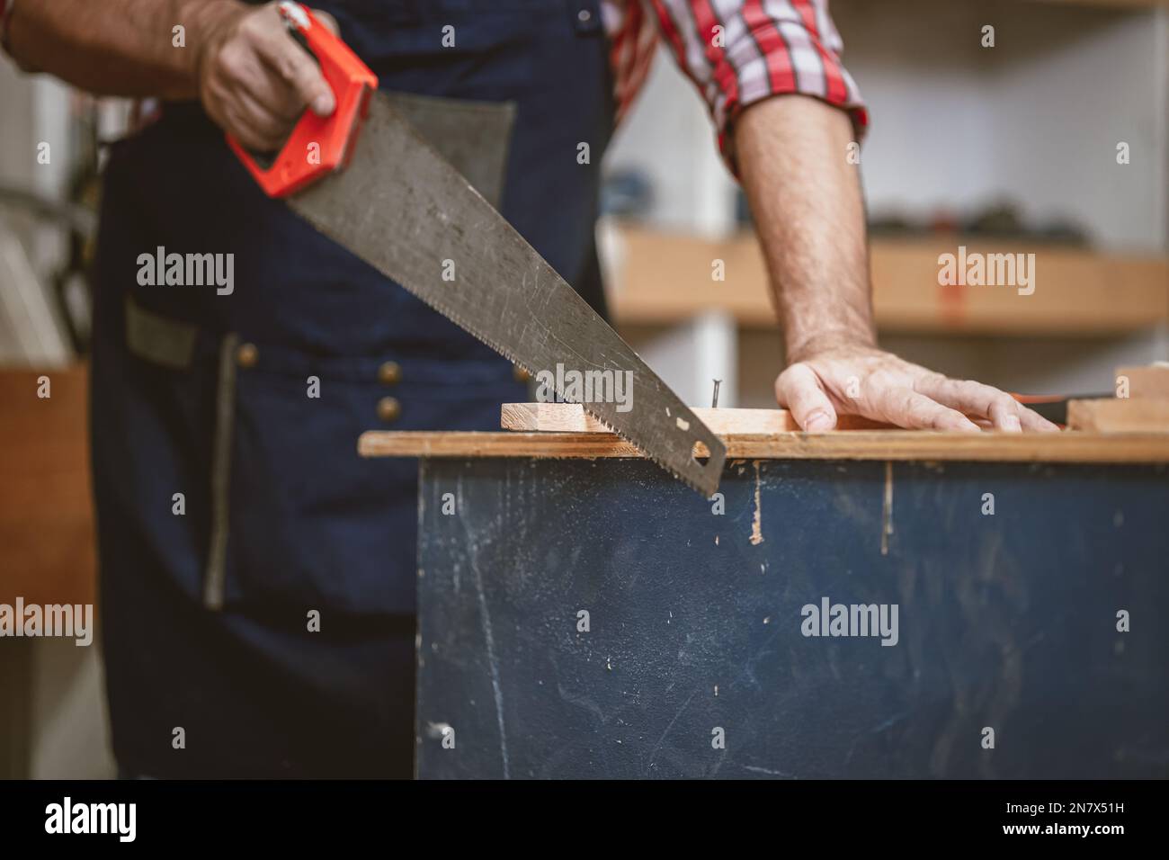 home builder working cutting wood panel with saw tool. diy wood ...