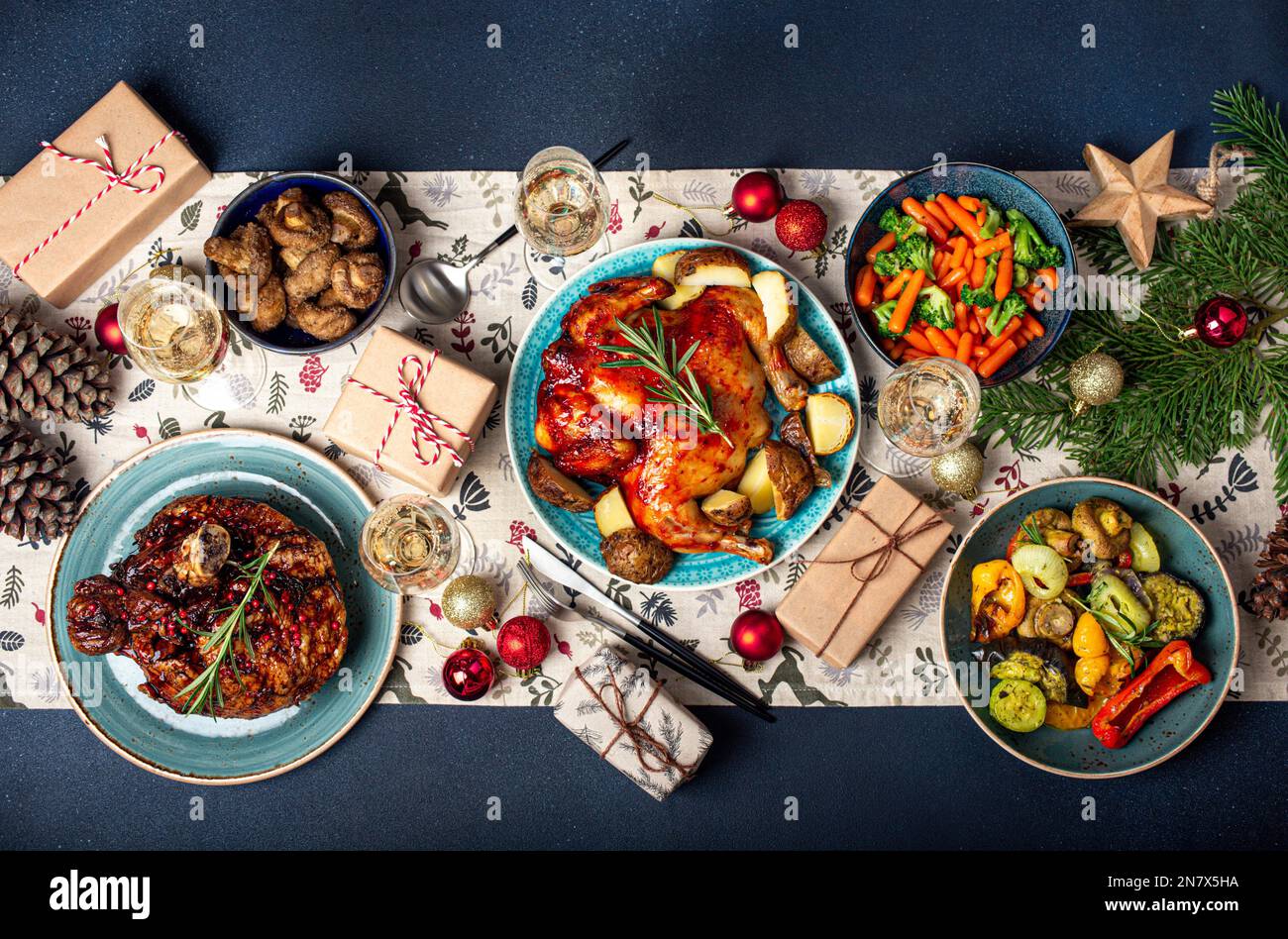 Christmas evening table top view with festive food and sparkling wine ...