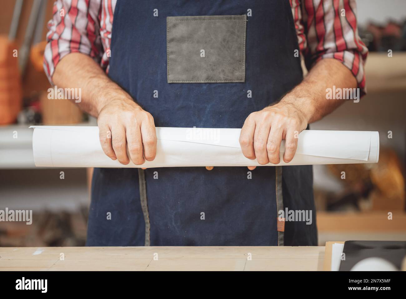 closeup hand of builder with floor plan paper roll for smart home ...