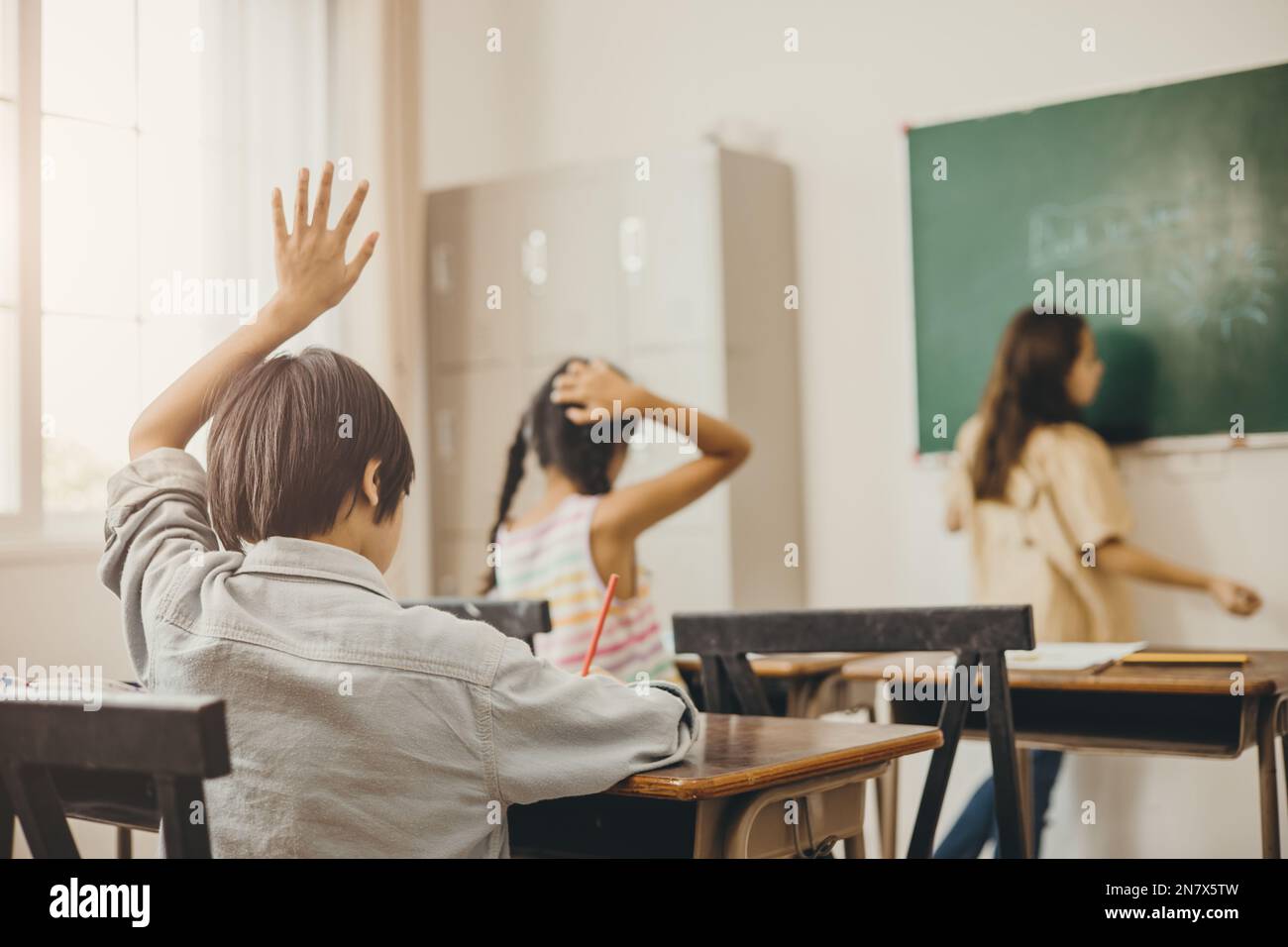 kids education in the school class room. boy hand rise for asking ...