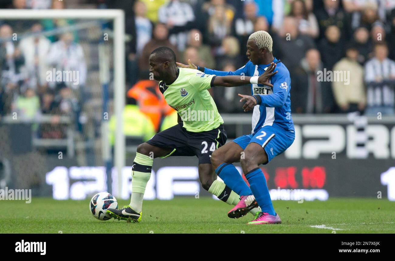 Wigan Athletic's Arouna Kone, right, fights for the ball against ...