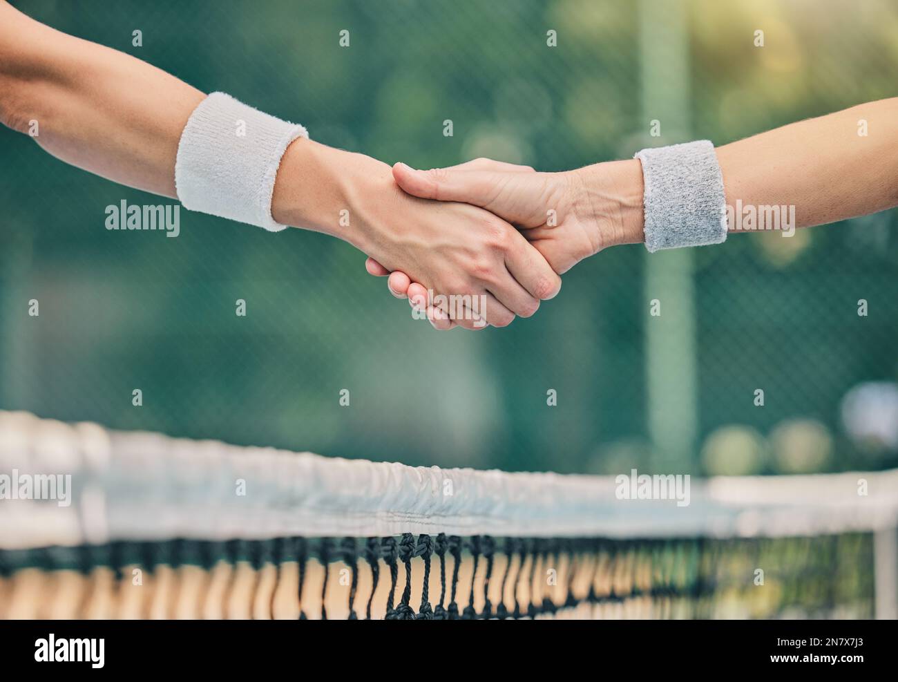 Hand, tennis and handshake for partnership, trust or greeting in ...