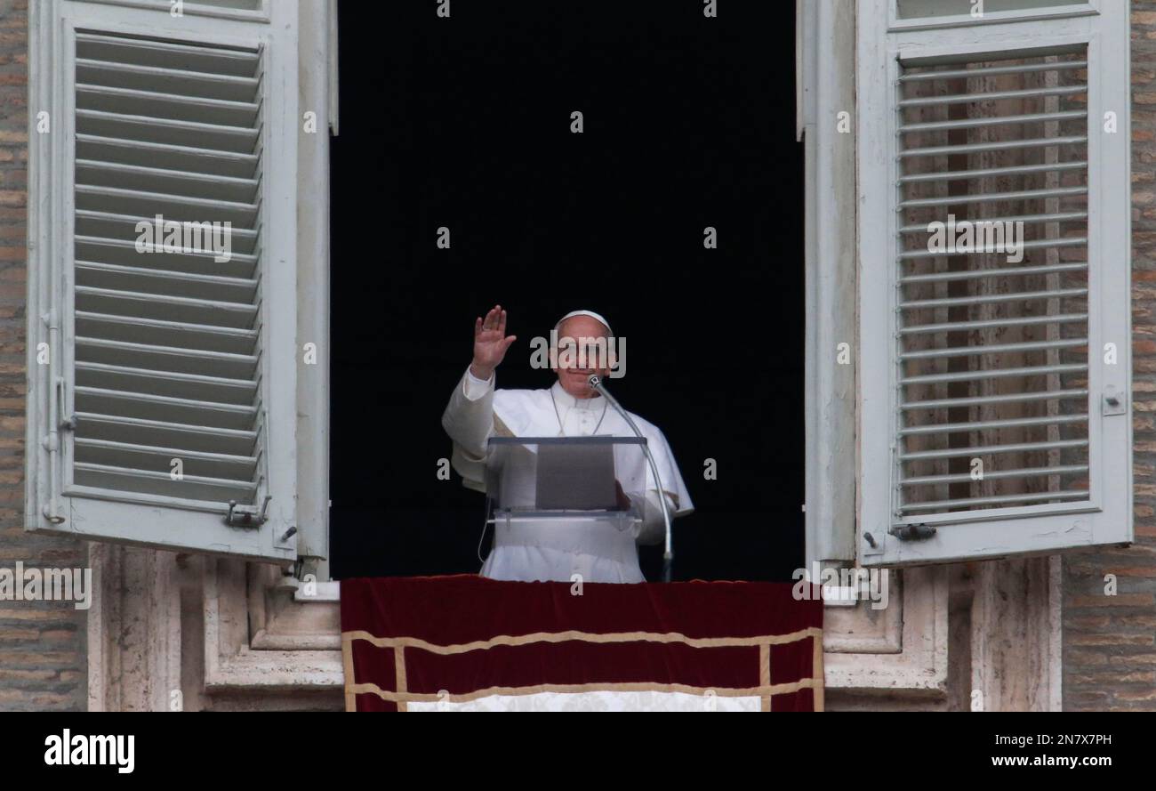 Pope Francis waves during his Angelus prayer from the window of his ...