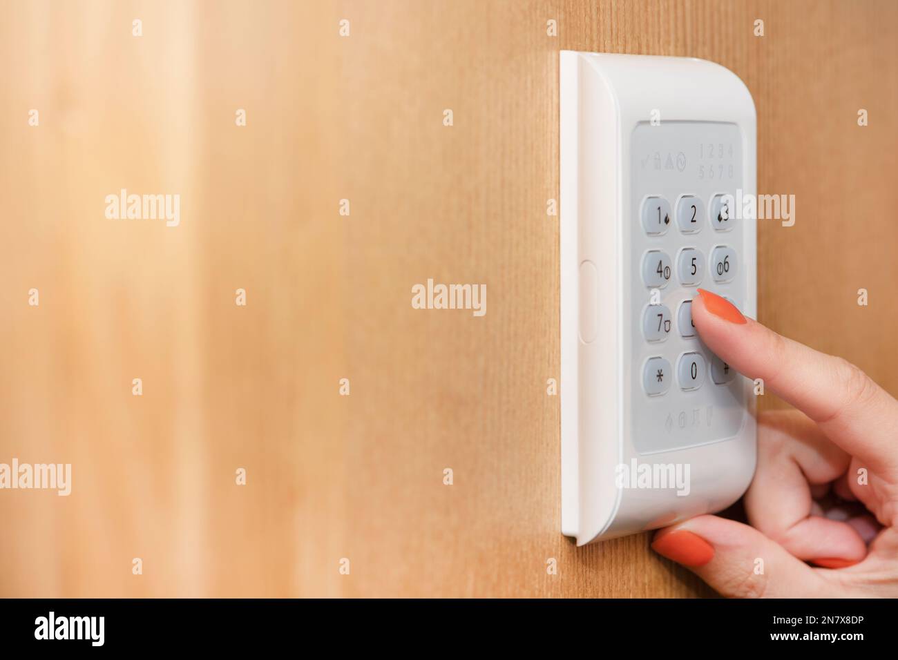 Alarm panel. The hand enters the code from the house security alarm ...