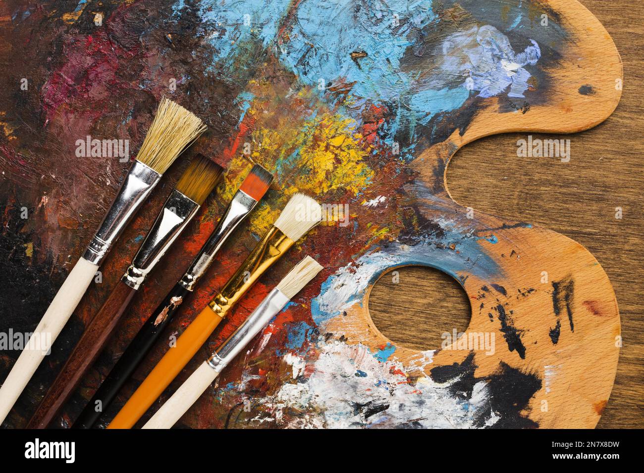 front view dirty color palette with brushes Stock Photo - Alamy