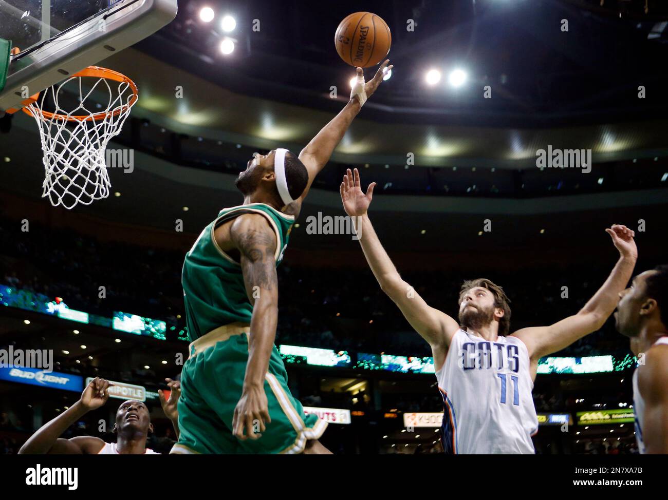 Boston Celtics' Chris Wilcox, center left, reaches for a rebound in ...