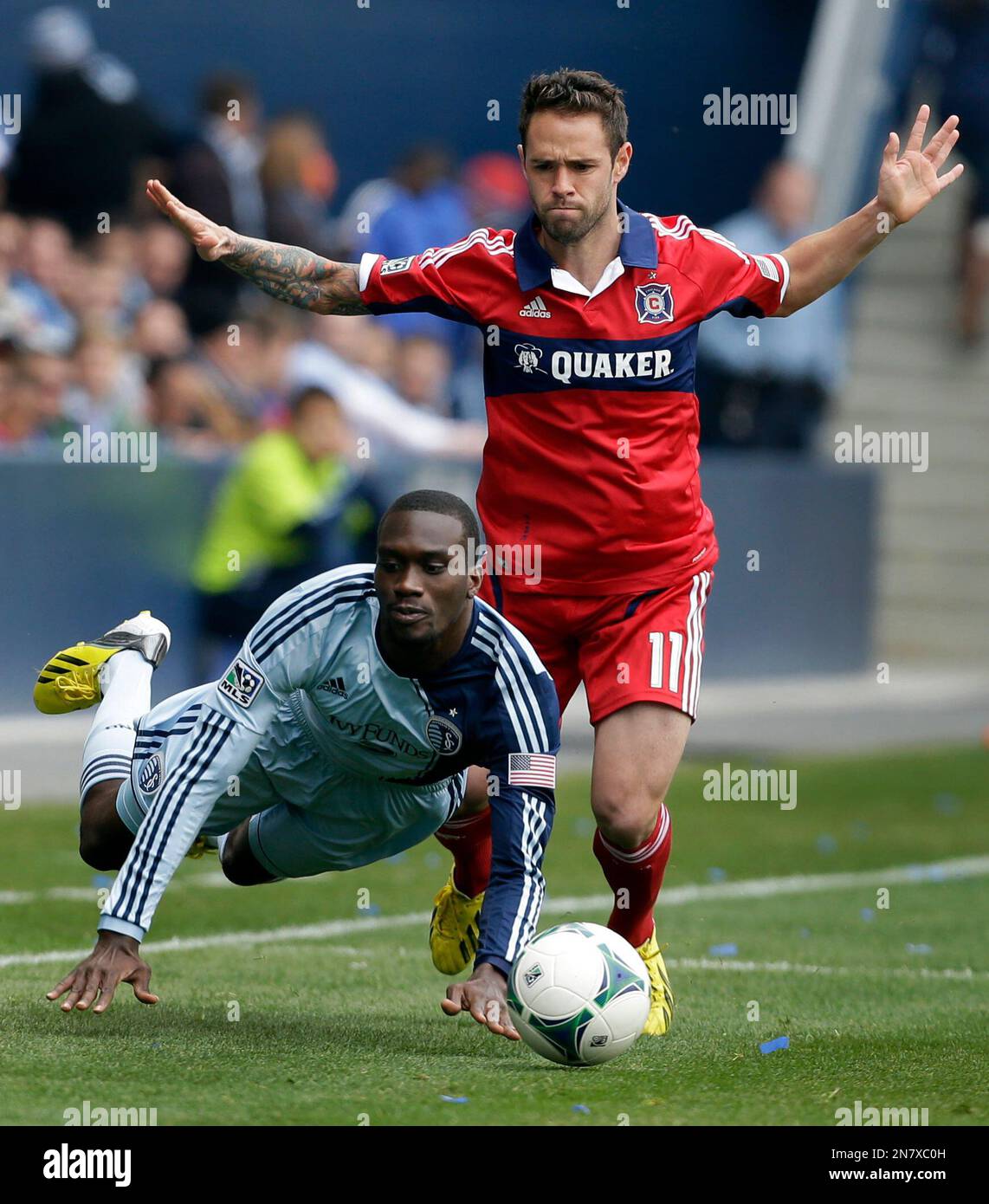 Chicago Fire midfielder Daniel Paladini (11) knocks down Sporting ...