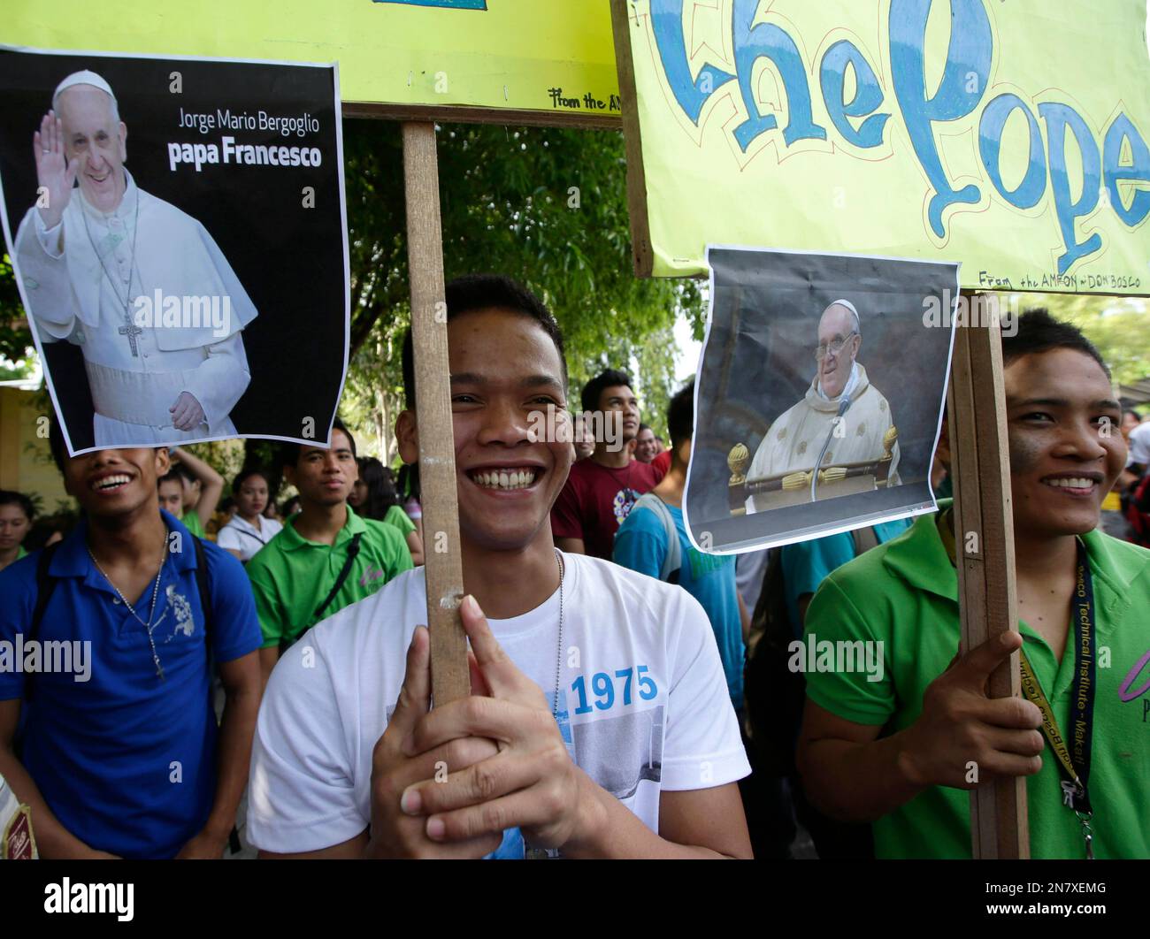Filipino Catholic devotees display placards as they cheer for the ...