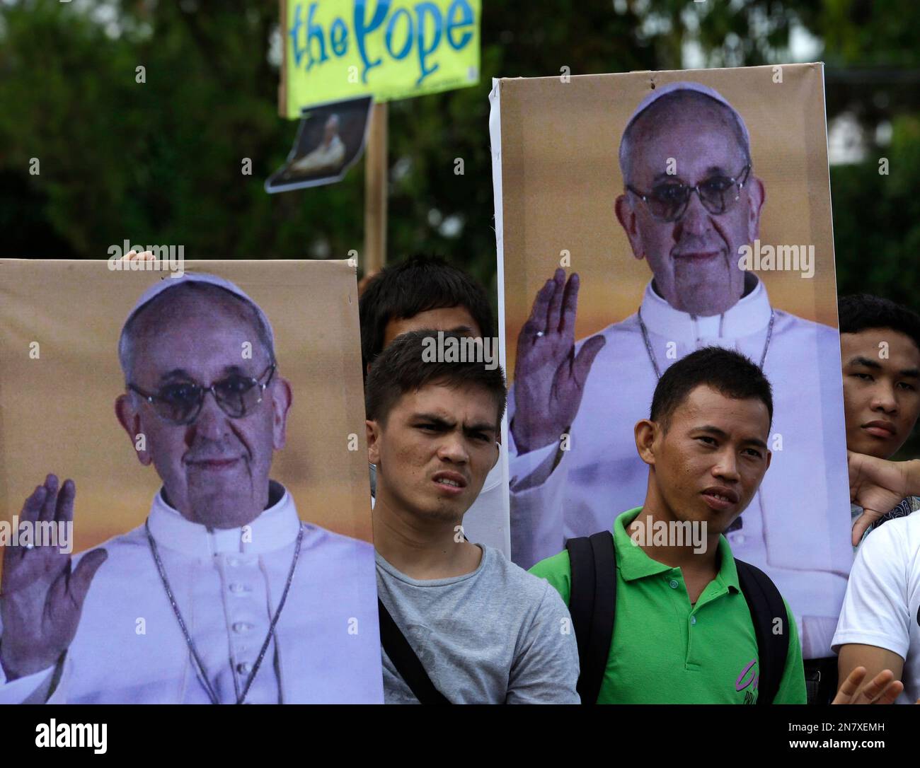Filipino Catholic devotees display portraits of new Pope Francis during ...
