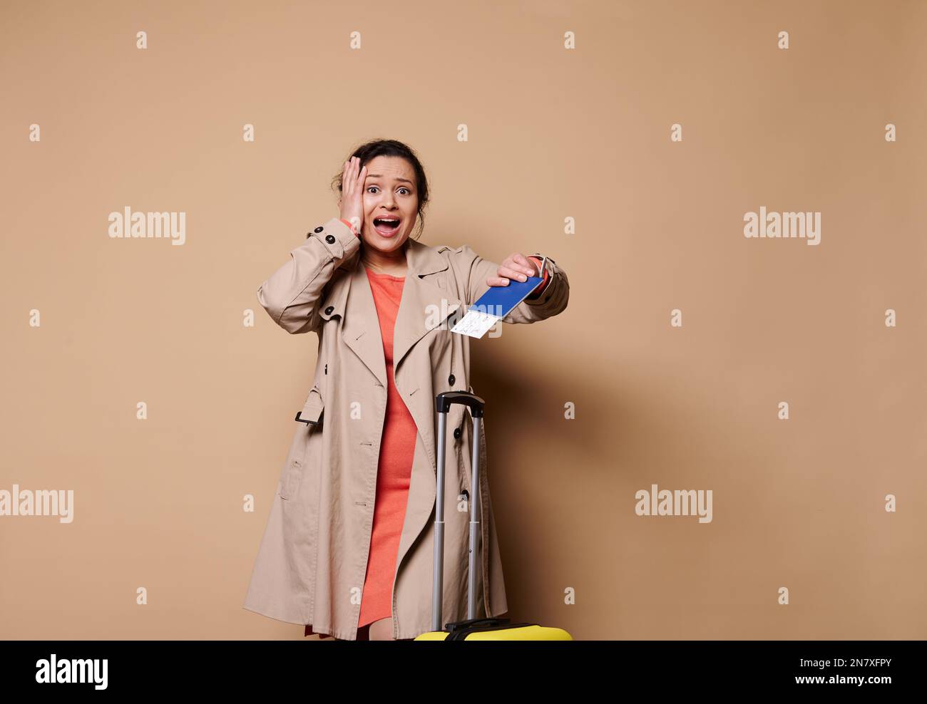 Pretty female passenger holds her air ticket and boarding pass ...