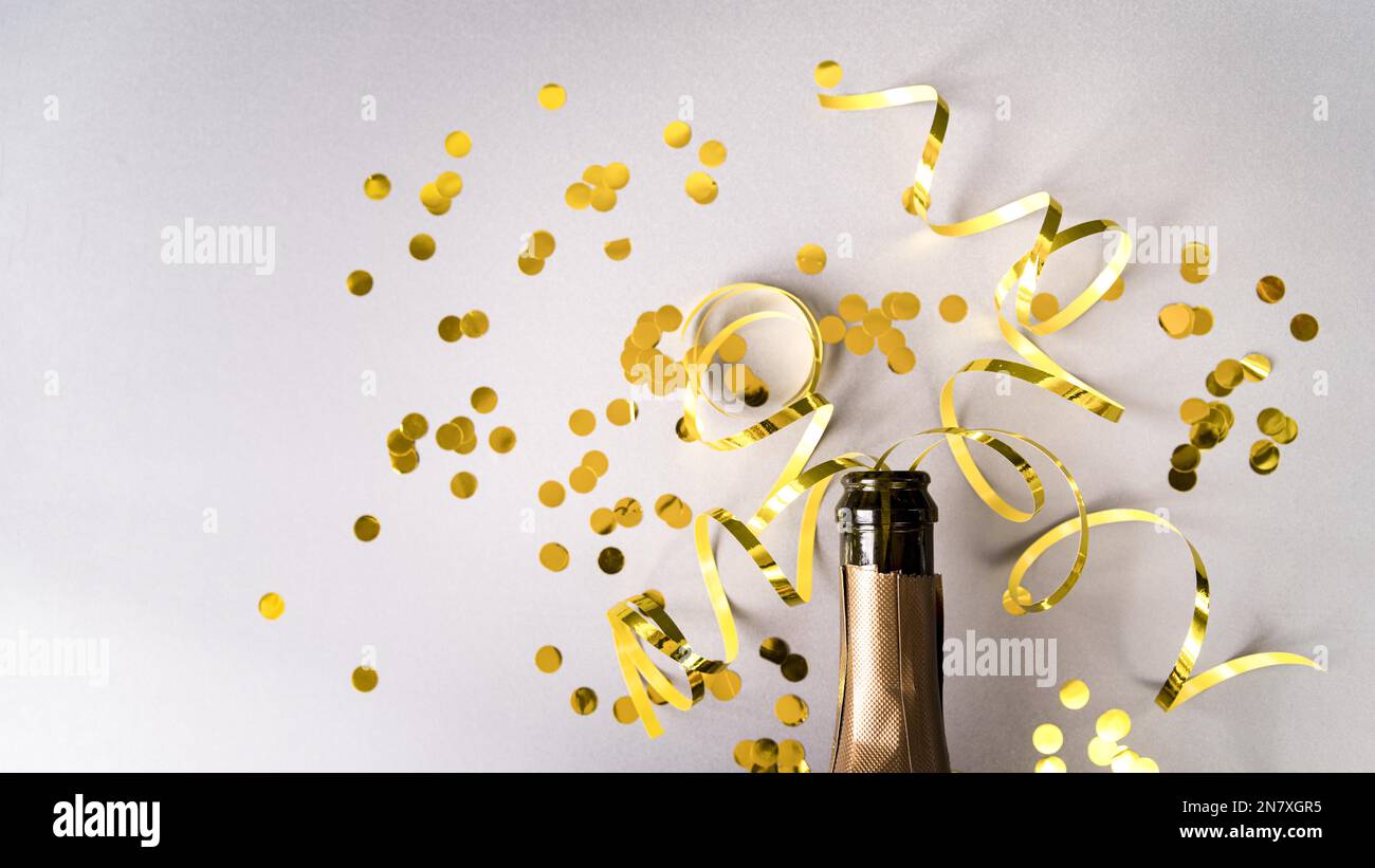 champagne bottle with golden confetti streamers white background Stock ...