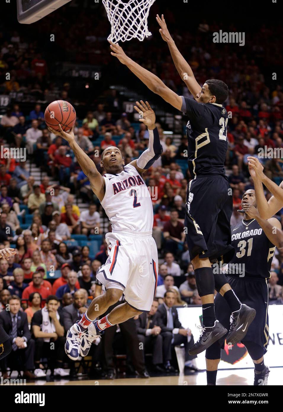 Arizona's Mark Lyons shoots against Colorado's Andre Roberson during a ...