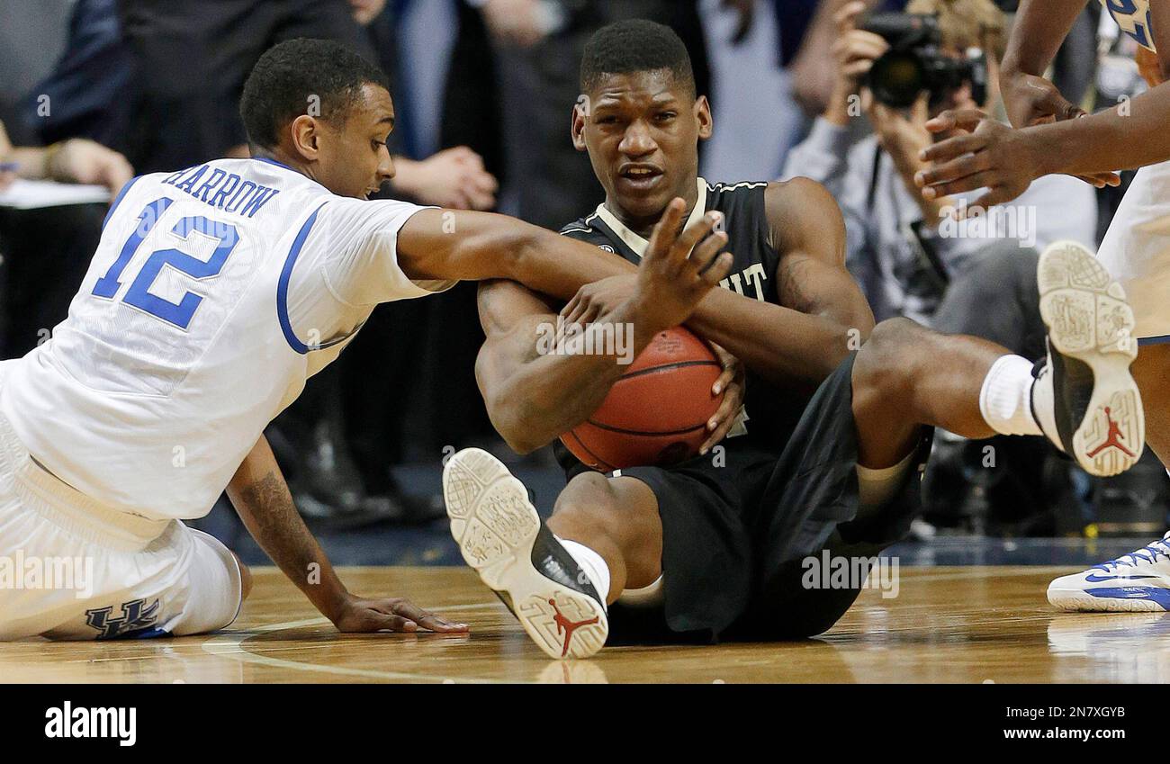 Kentucky guard Ryan Harrow (12) battles for a ball held by Vanderbilt ...