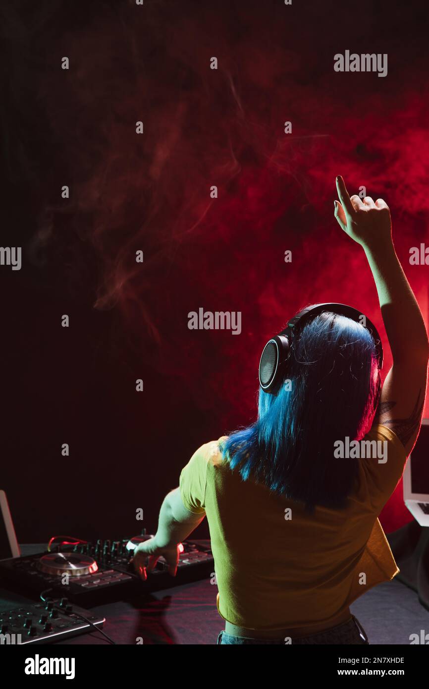 back view dj woman setting party mood Stock Photo - Alamy
