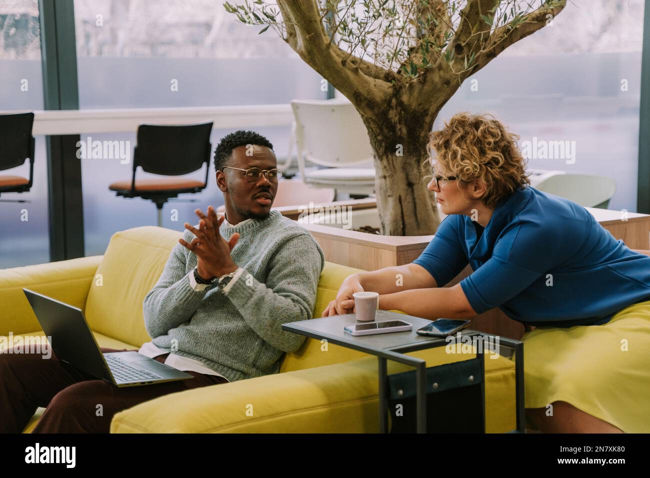 Two multiethnic colleagues are looking for a solution of the project's ...