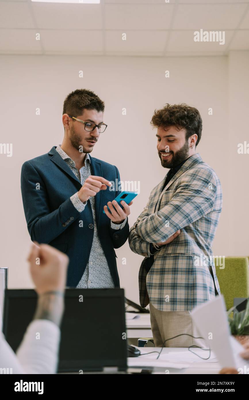 Smart eccentric businessman is showing his partner the background for ...