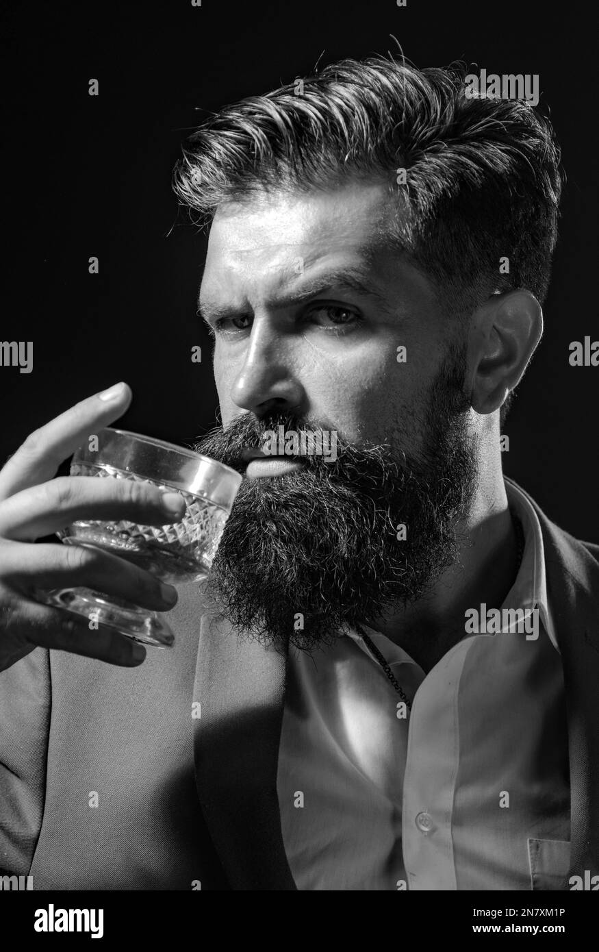 Bartender with glass whiskey. Sad man with depression looking in camera. Alcoholic drinking ...