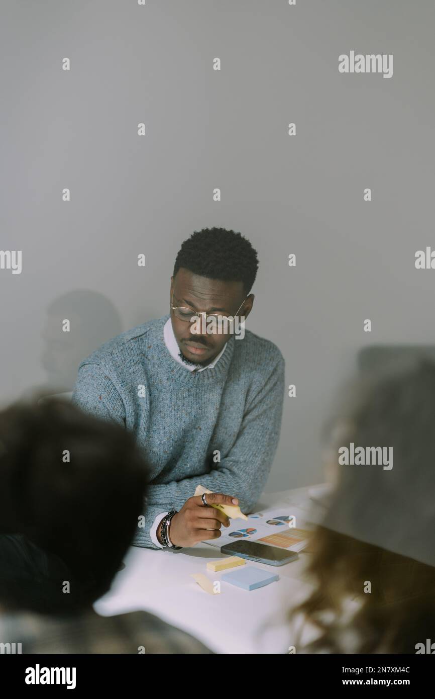 A handsome male business person underlining important parts of the ...