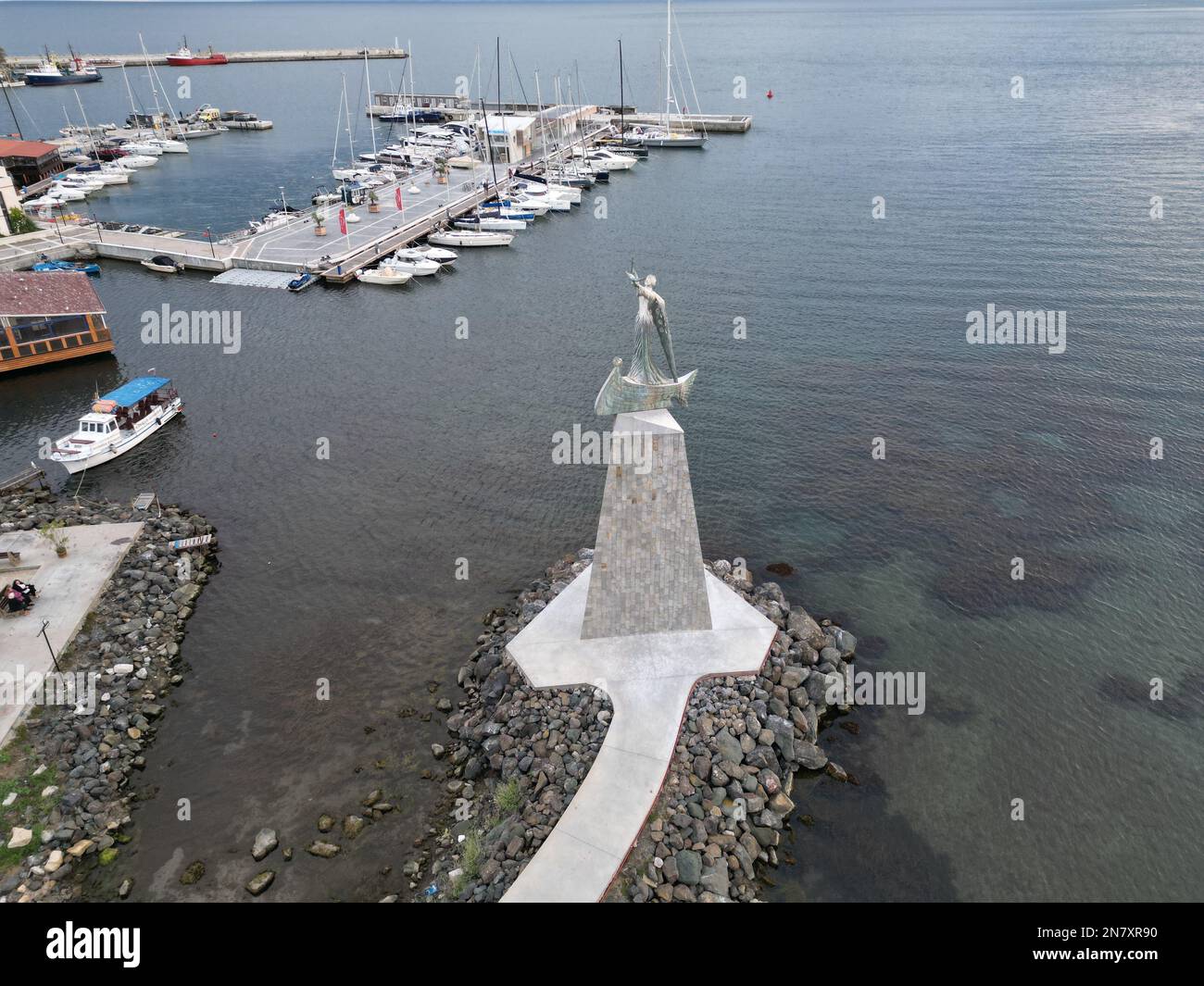 An aerial shot of Statue of St. Nicholas and boats in a harbor in ...