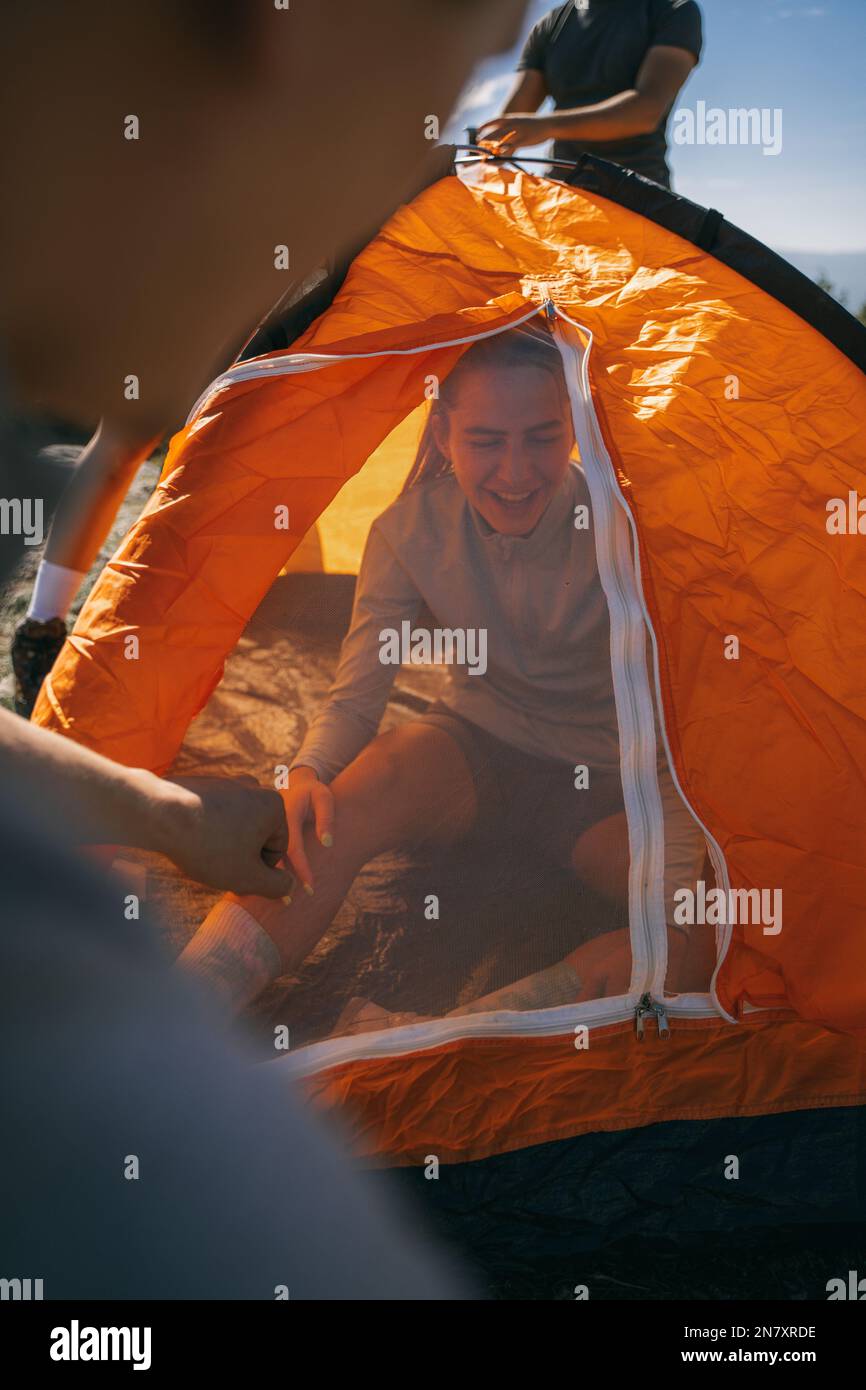 Pretty girl inside the orange tent laughing Stock Photo - Alamy