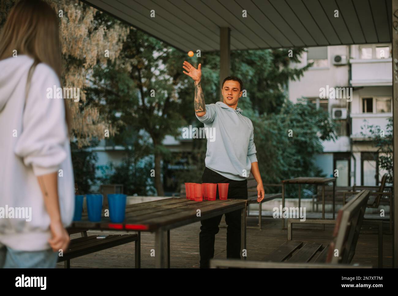 Handsome boy throwing the ball at the cups of his friend Stock Photo ...