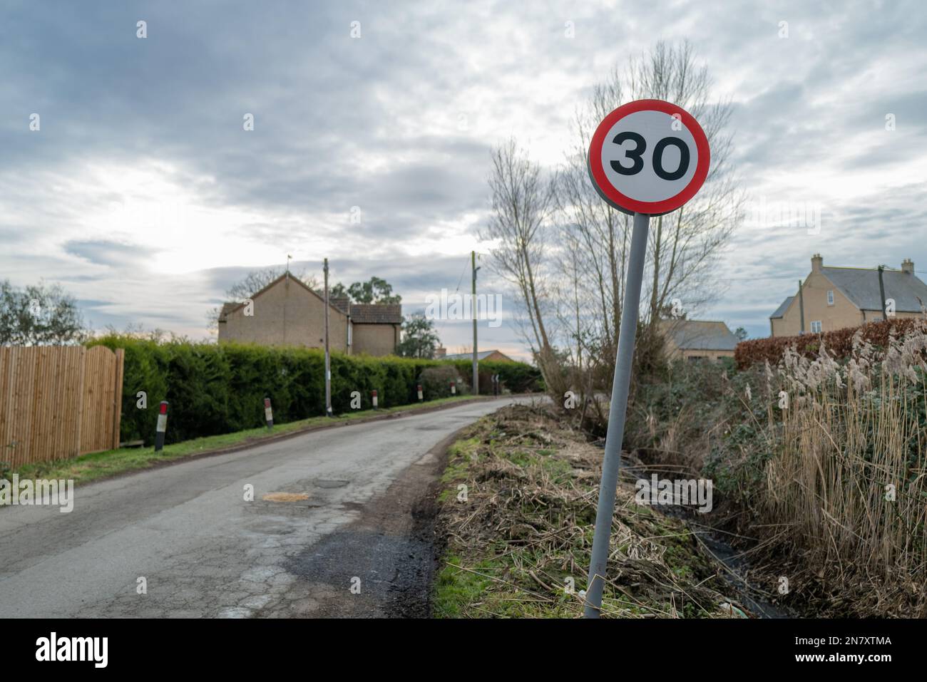Bent over 30 Mph speed limit sign seen approaching a small, rural ... Bent over 30 Mph speed limit sign seen approaching a small, rural ...
