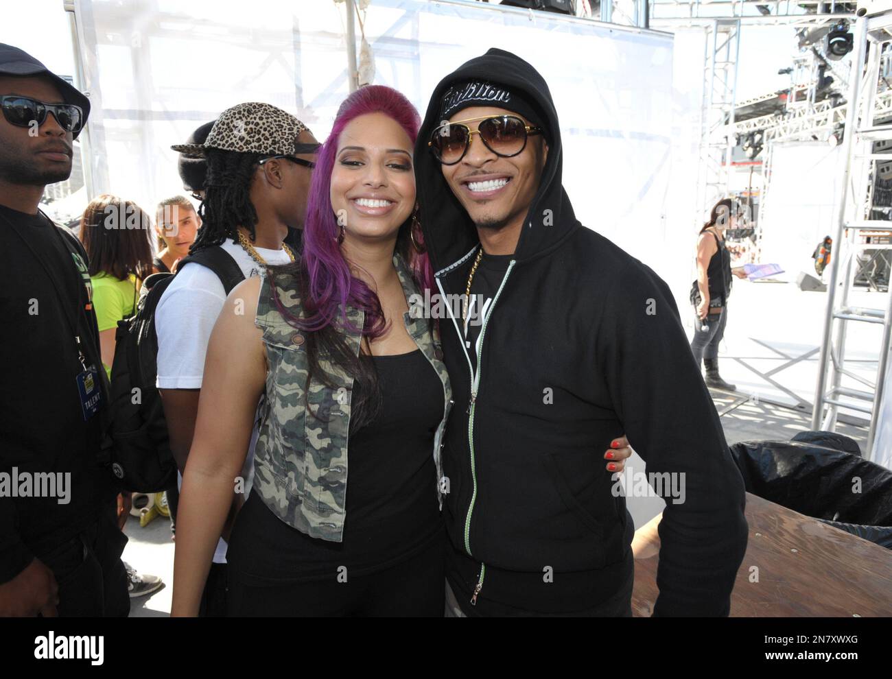 MTV's Nessa, left, and rapper T.I. pose backstage at the mtvU Woodie ...