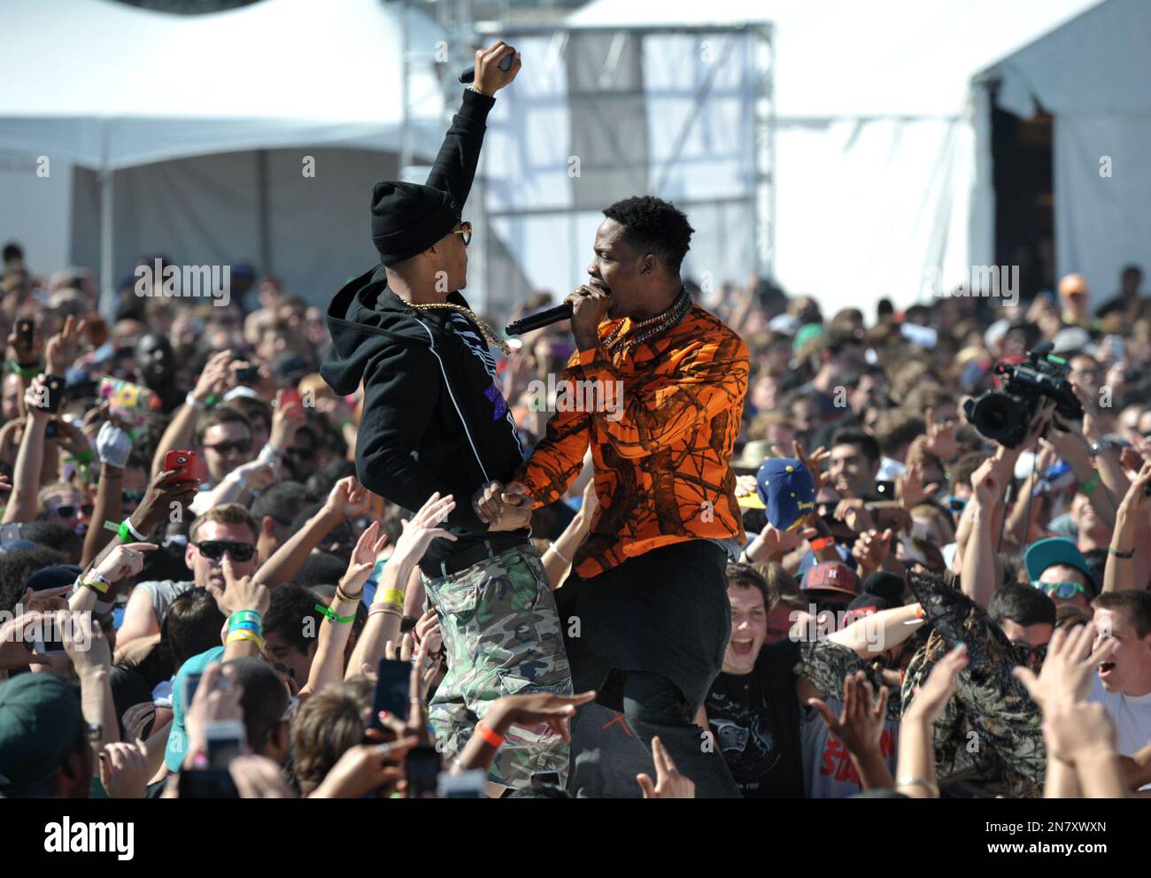 Rappers T.I., left, and Travi$ Scott perform at the mtvU Woodie Awards ...