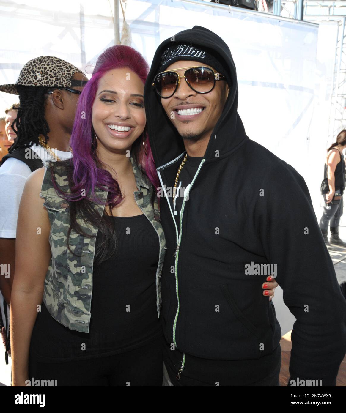 MTV's Nessa, left, and rapper T.I. pose backstage at the mtvU Woodie ...