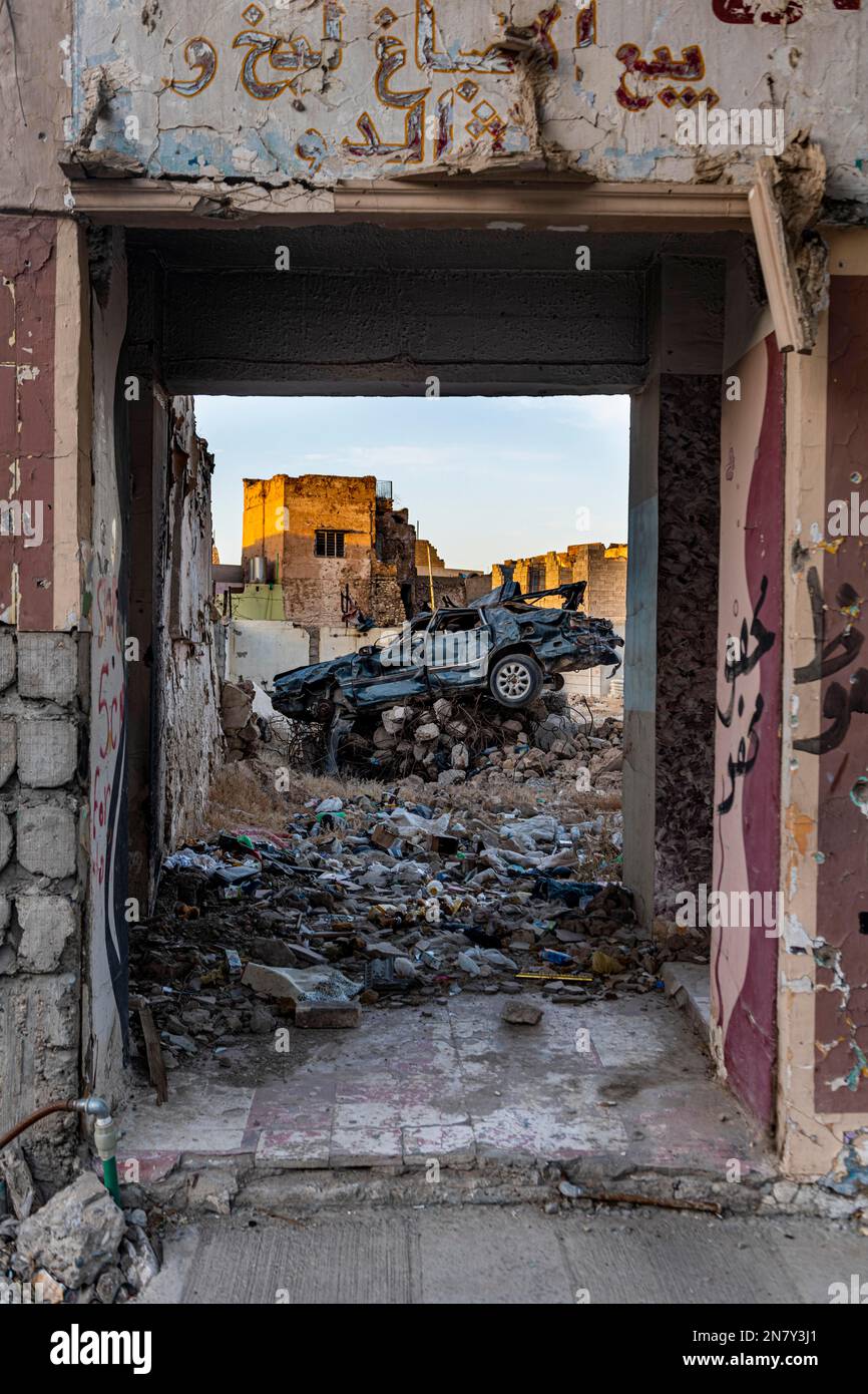 Demolished car in a destroyed house from ISIS, Mosul, Iraq Stock Photo ...