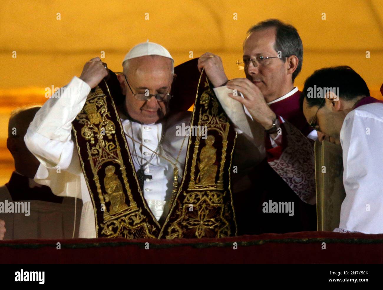Pope Francis puts on his sash from the central balcony of St. Peter's ...