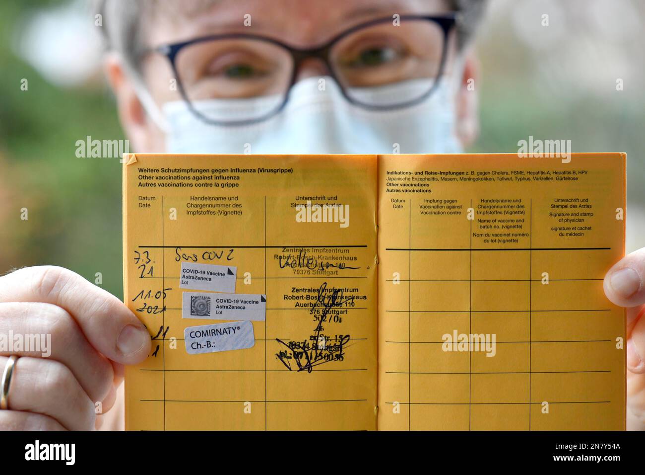 Woman proudly showing her vaccination certificate after third booster ...