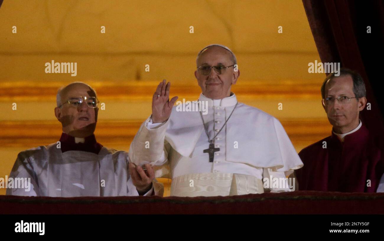 Pope Francis waves to the crowd from the central balcony of St. Peter's ...