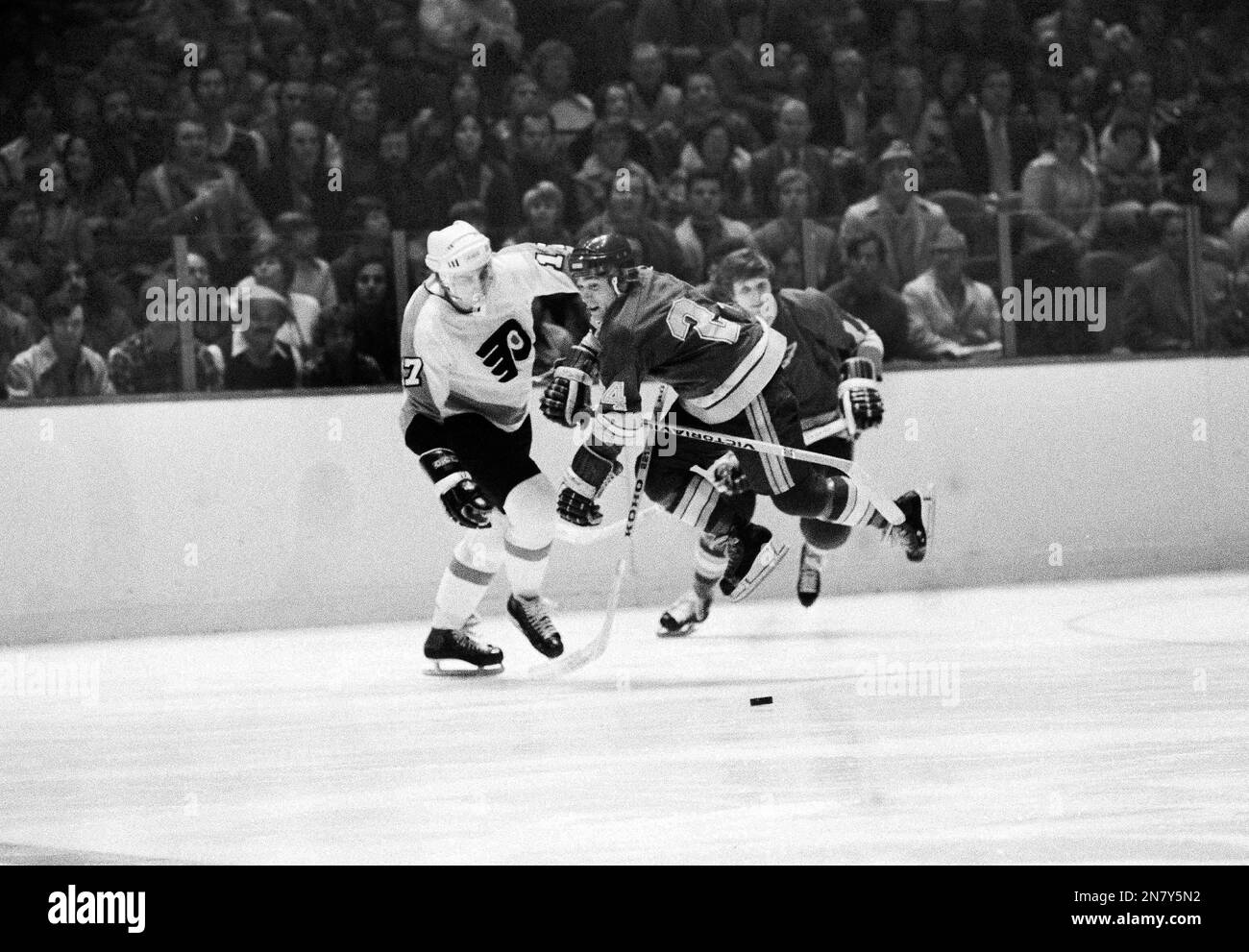 Bob Gassoff (3) of the St. Louis Blues flips Flyers' Paul Holmgren to ...
