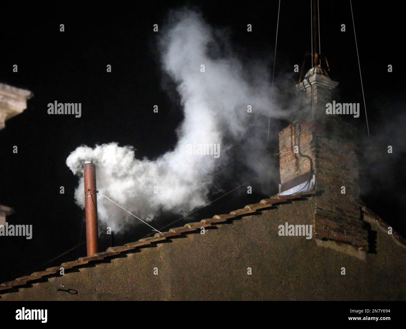 White smoke emerges from the chimney on the roof of the Sistine Chapel ...
