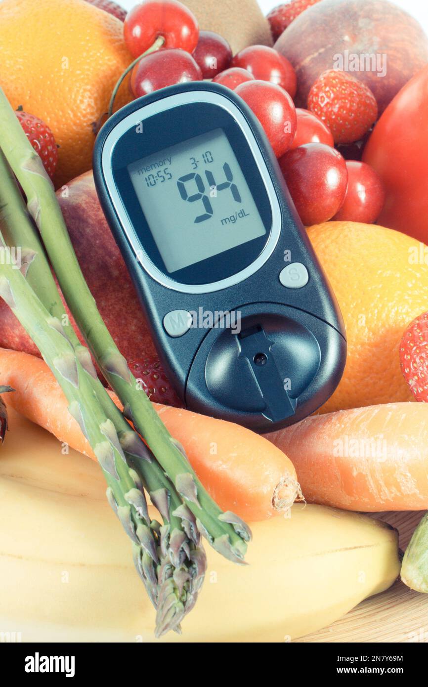 Glucometer with result of measurement sugar level and fresh ripe ...