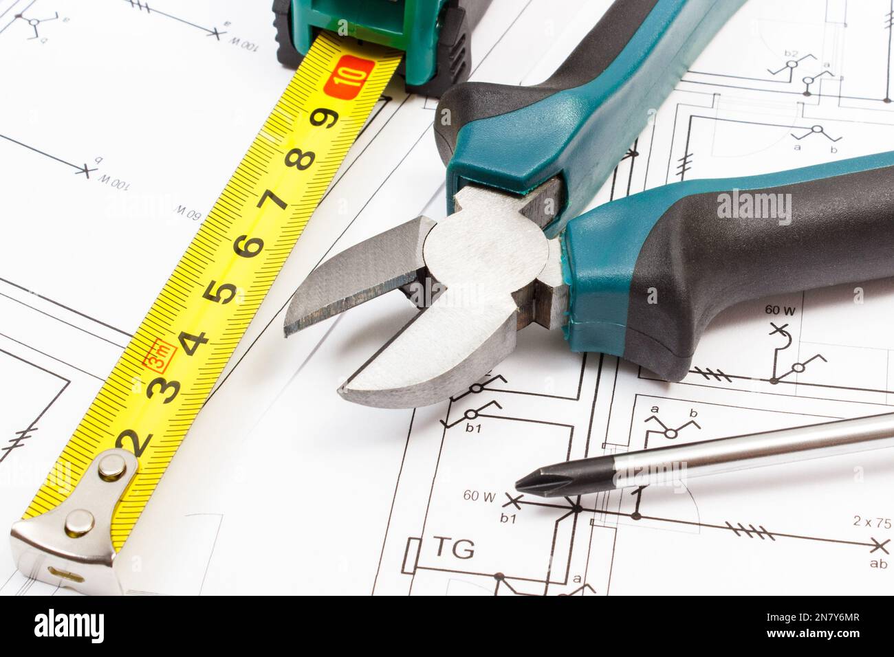 Metal pliers, tape measure and screwdriver with electrical construction ...