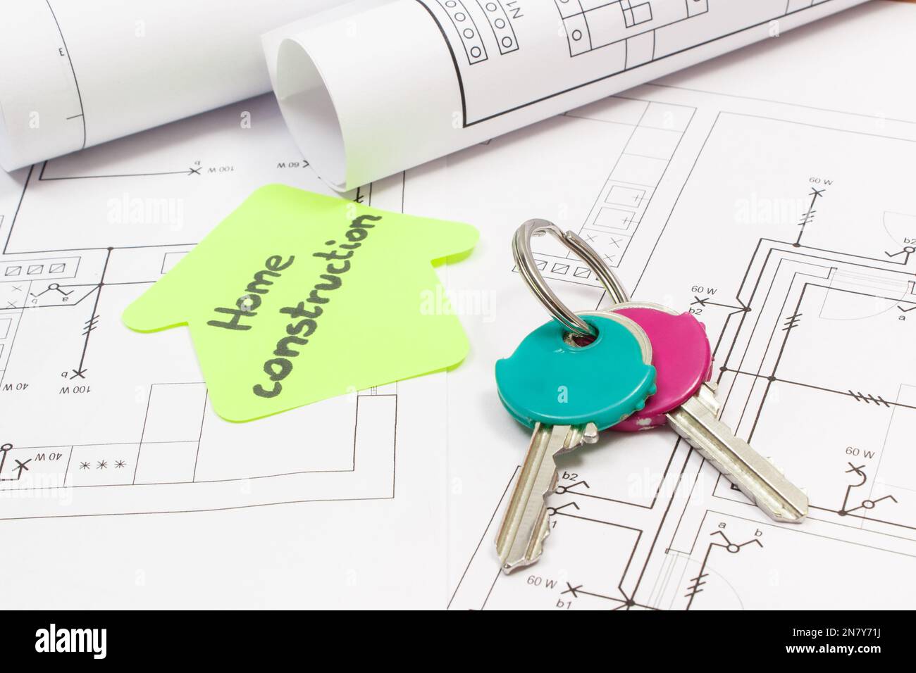 House shape made of paper, home keys and diagrams of plan with ...