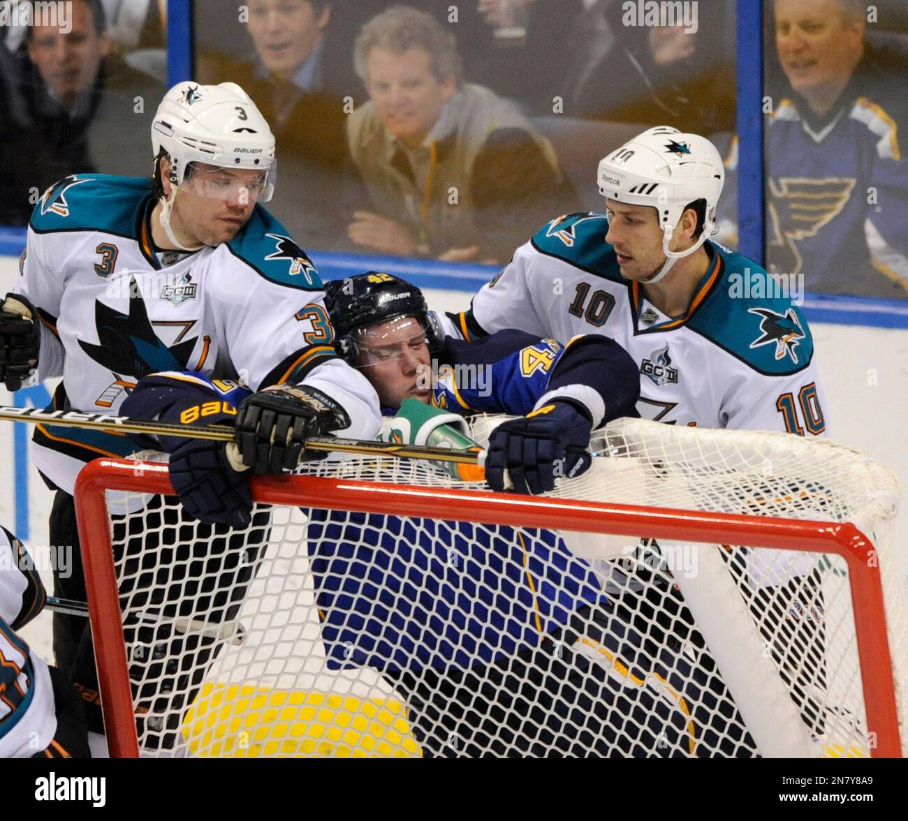 St. Louis Blues' David Backes (42) is pushed into the net by San Jose ...