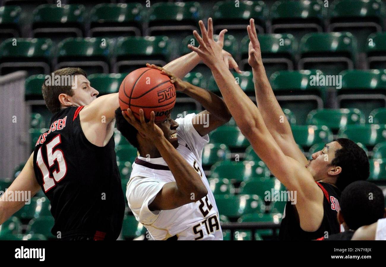 Texas State's Basil Brown (22) shoots the ball under pressure from ...