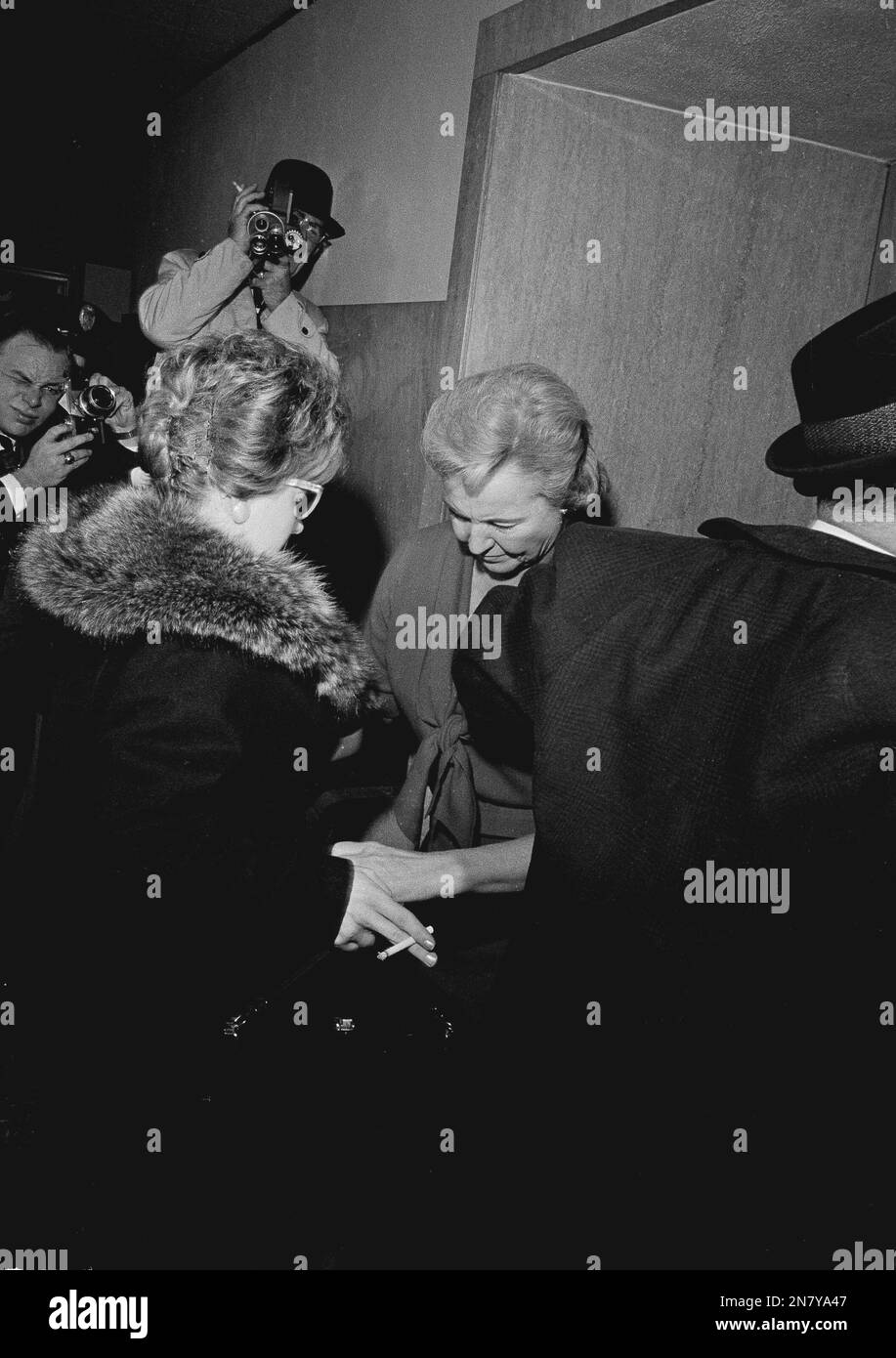 An unidentified police woman searches Karen Lyn Bennett, 19, left, in ...