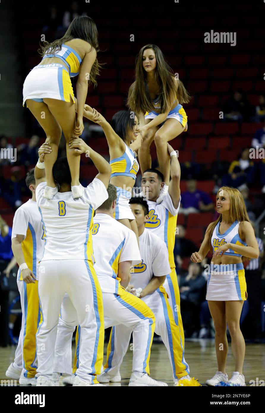 UCLA cheerleaders perform during an NCAA college basketball game ...