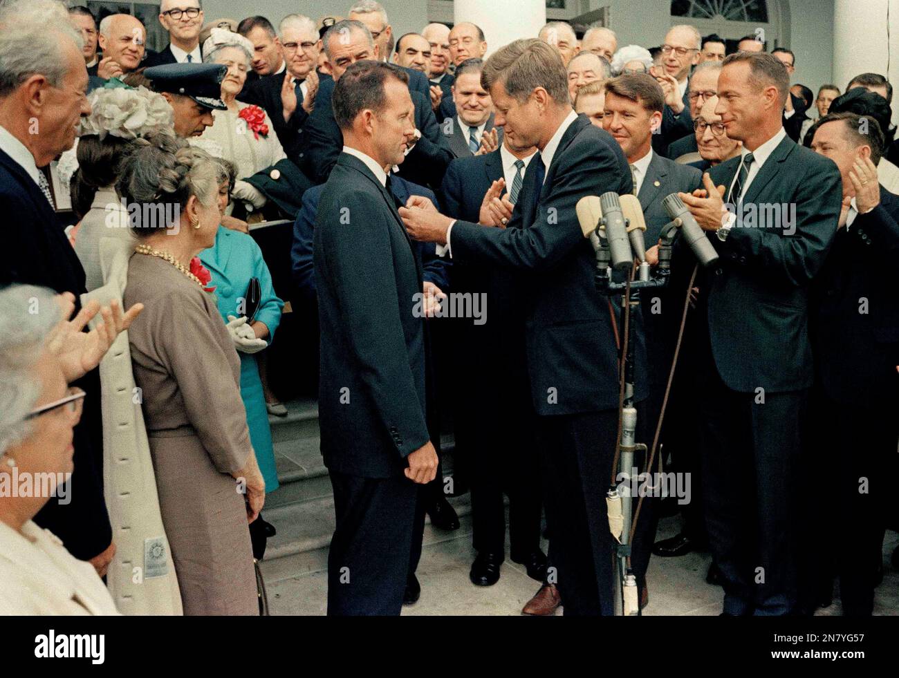 U. S. President John F. Kennedy, right, shakes hands with Astronaut ...