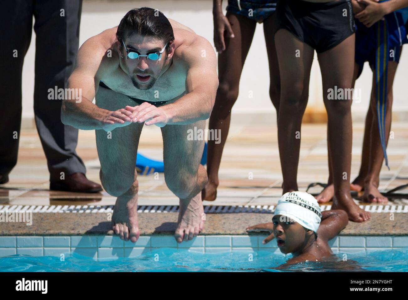 Former U.S. Olympic swimmer Michael Phelps dives into the pool as a ...