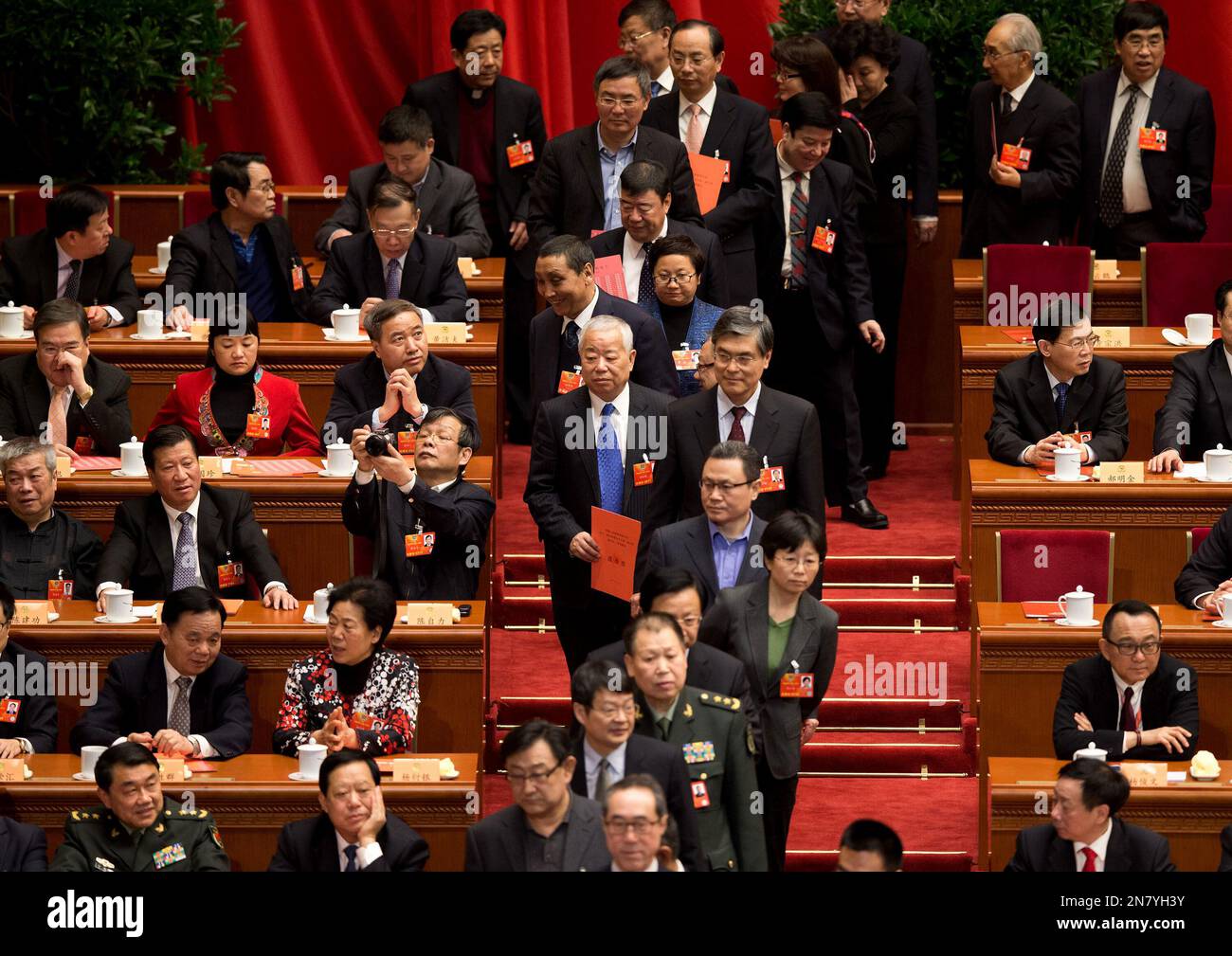 Delegates line up to cast their votes during a plenary session of the ...