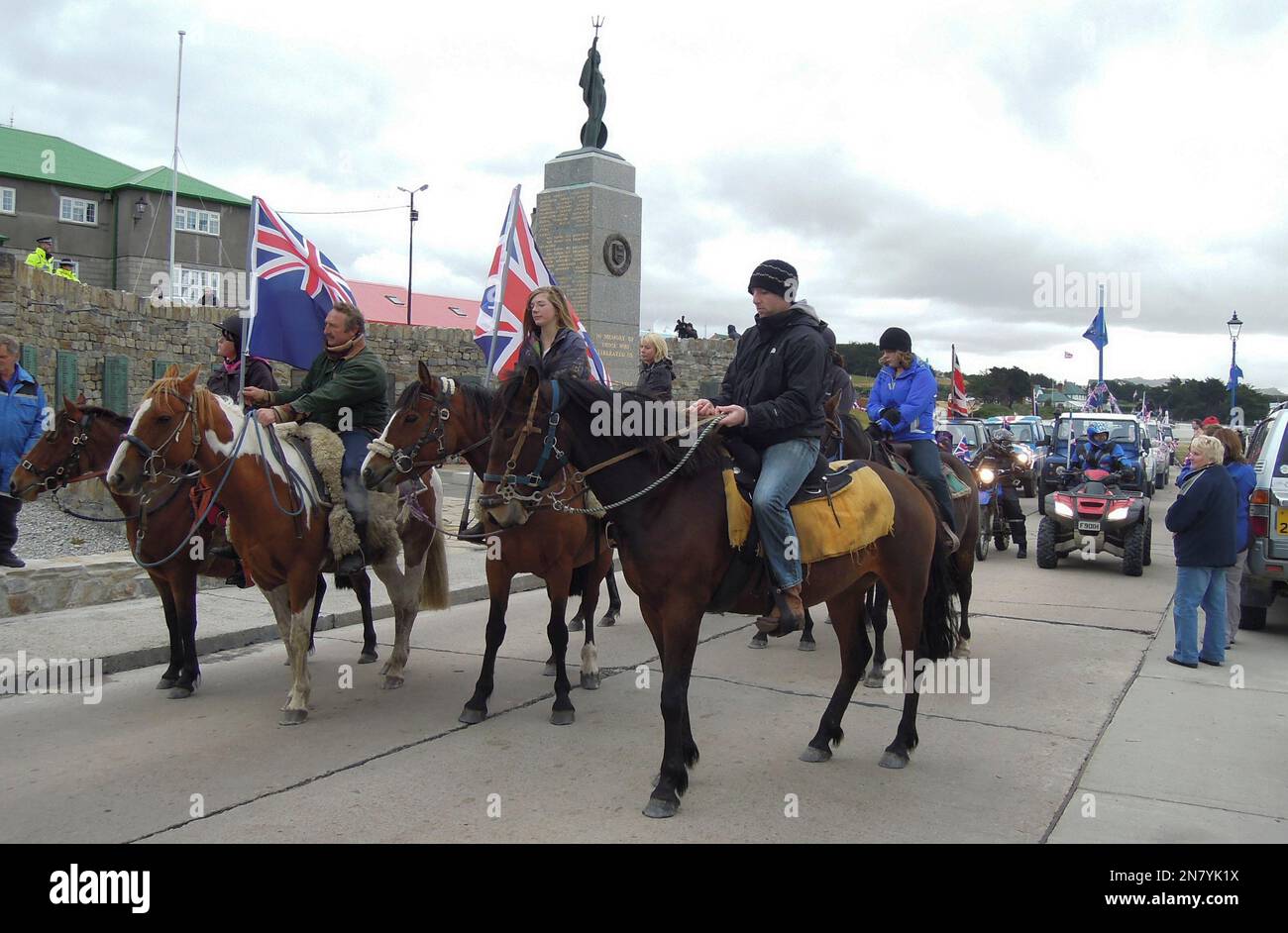 Residents, some carrying British flags, parade during a rally in ...