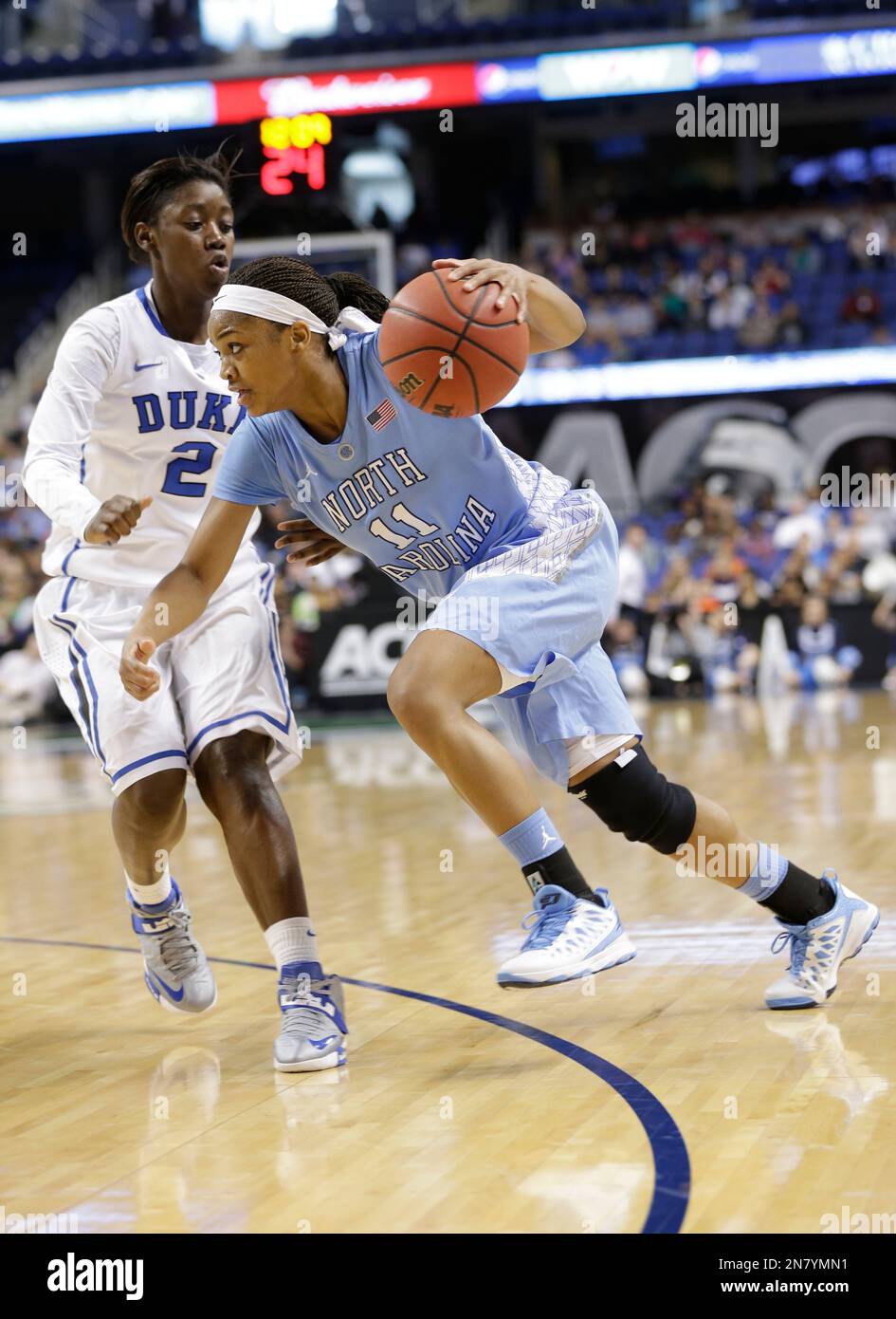 North Carolina's Brittany Rountree (11) drives past Duke's Alexis Jones ...