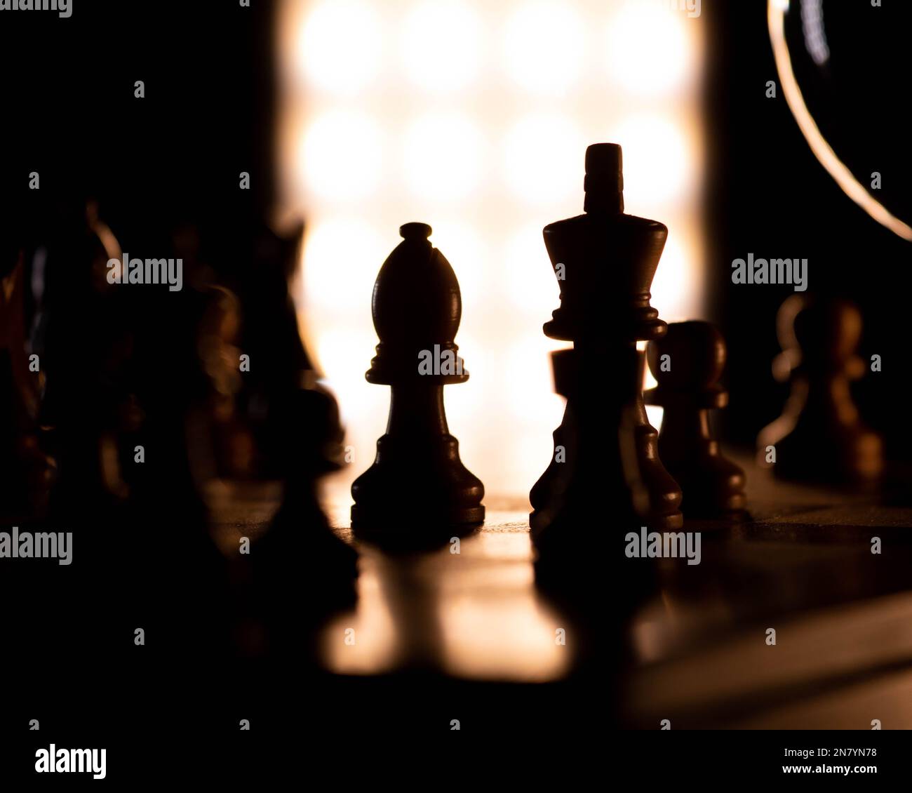 A closeup shot of king and queen chess pieces on a chessboard in the ...