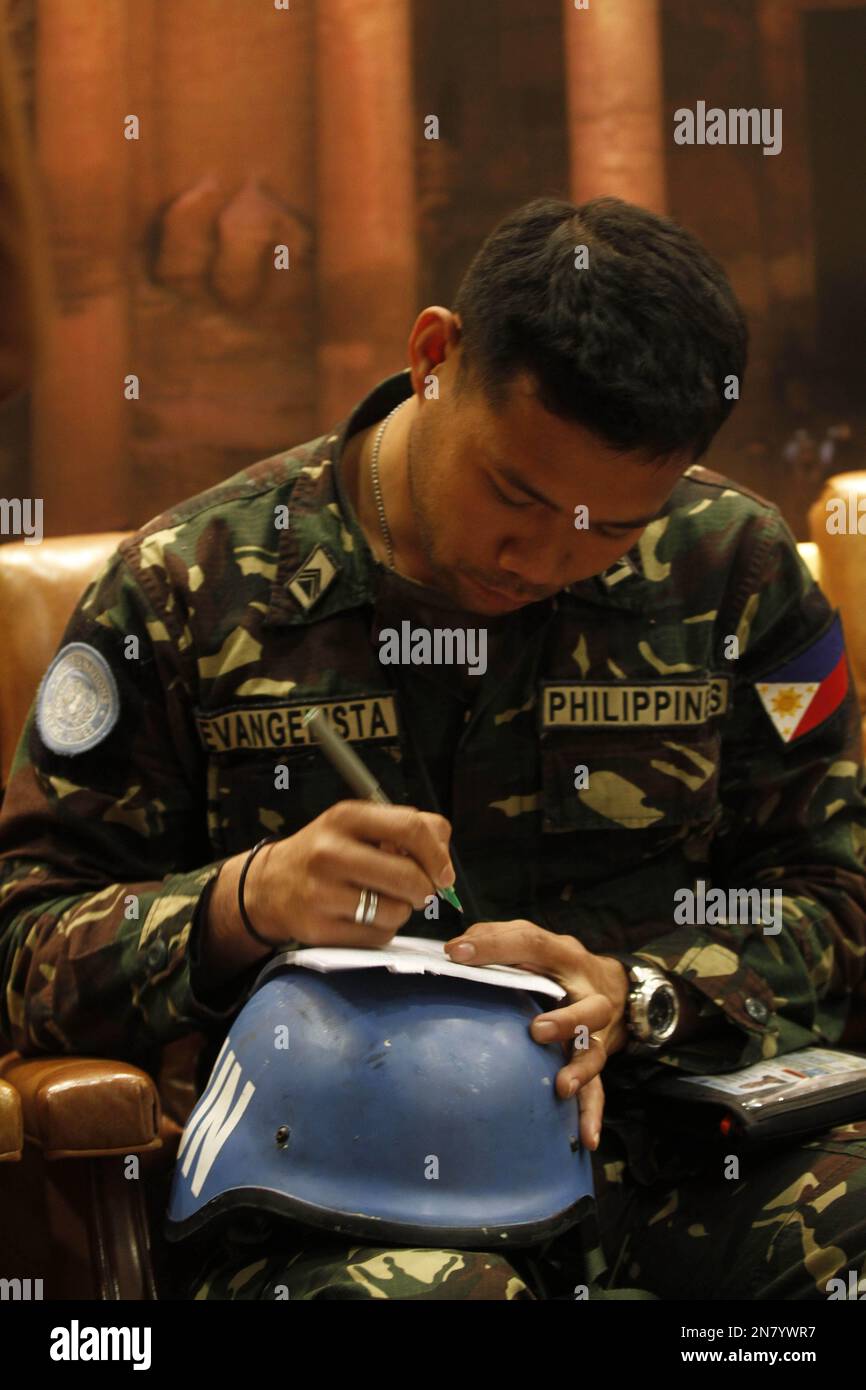 A Filipino UN peacekeeper registers his name upon his arrival at ...