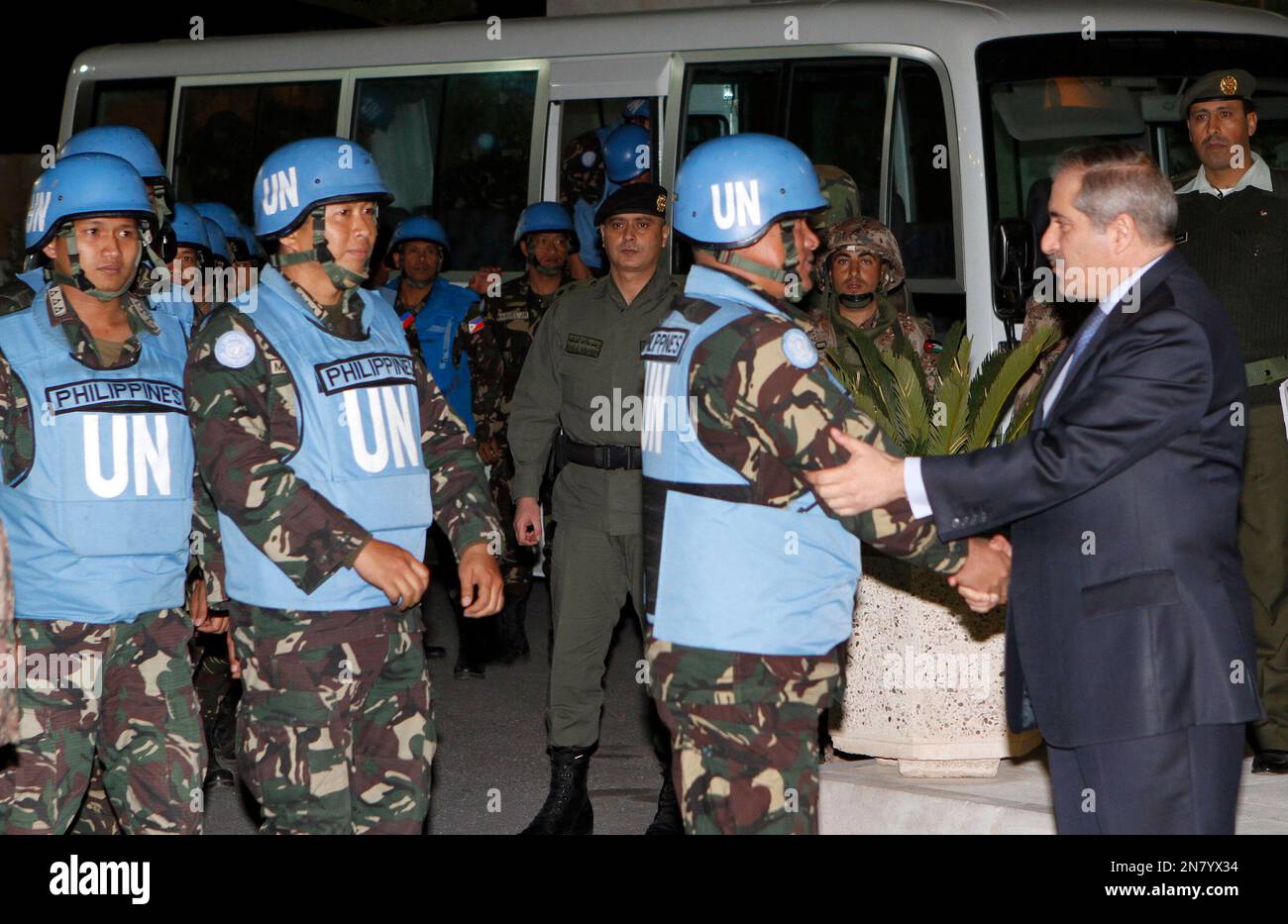Jordanian Foreign Minister, Nasser Judeh, right, welcomes 21 Filipino ...
